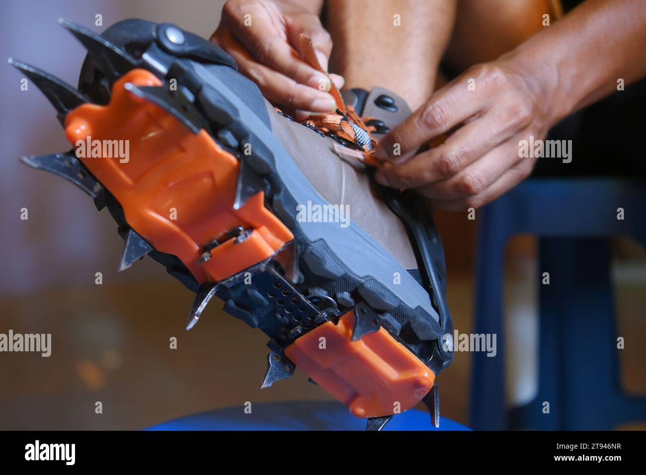 Aritra Roy, an IT professional and mountaineer, adjusting the spikes on ...