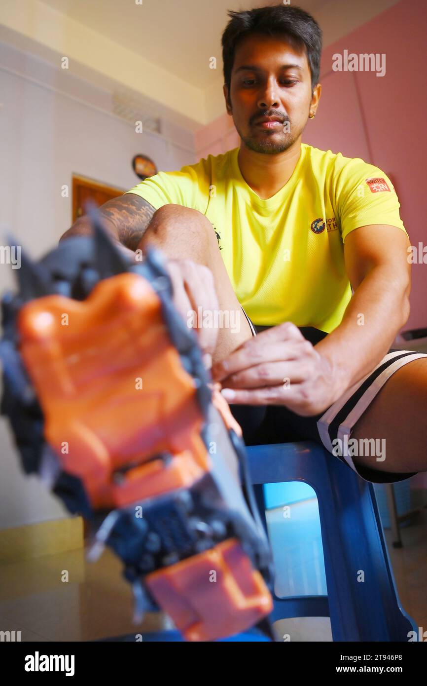 Aritra Roy, an IT professional and mountaineer, adjusting the spikes on ...