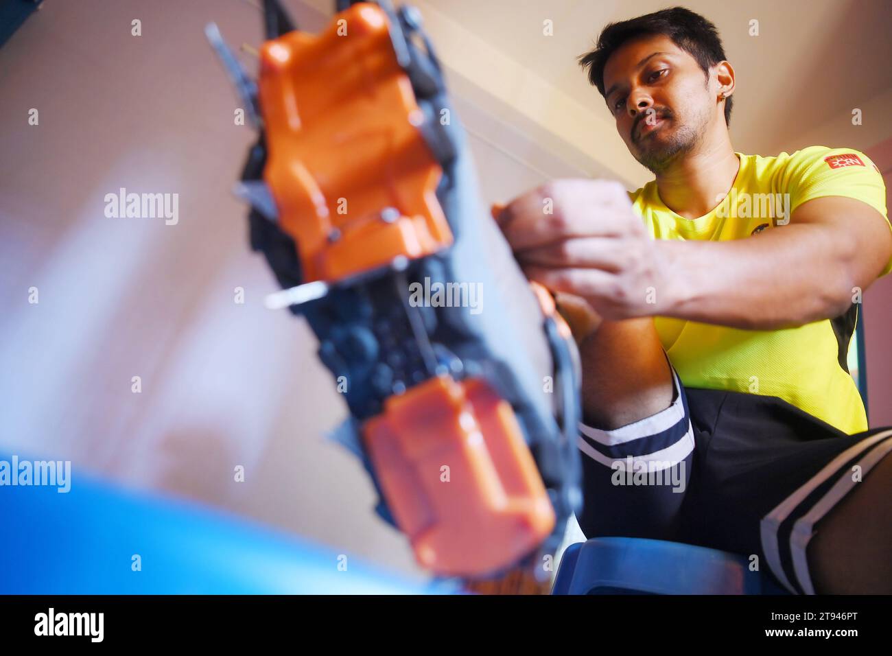 Aritra Roy, an IT professional and mountaineer, adjusting the spikes on ...