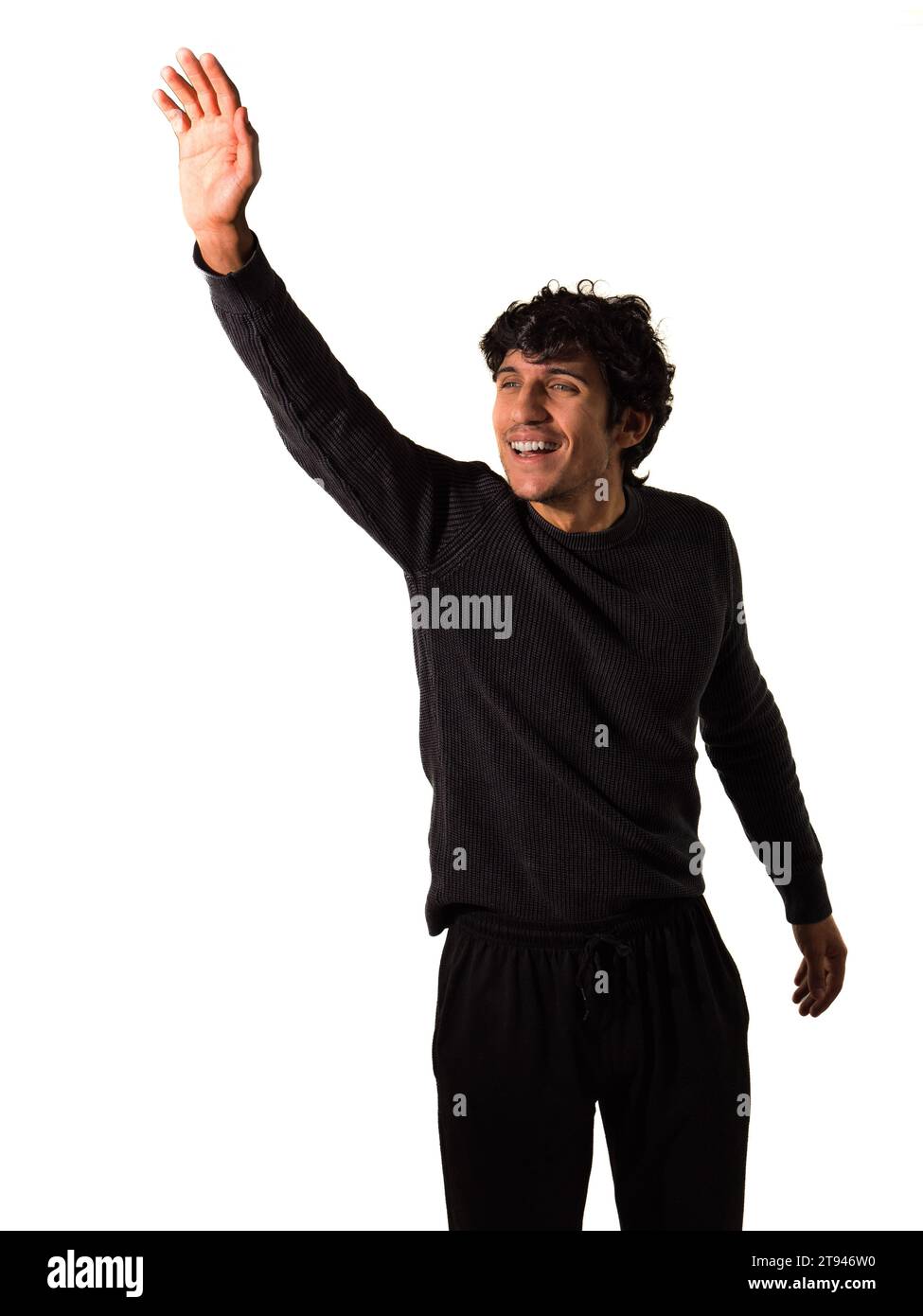 A man in a black shirt and black pants greeting with one hand, saluting ...