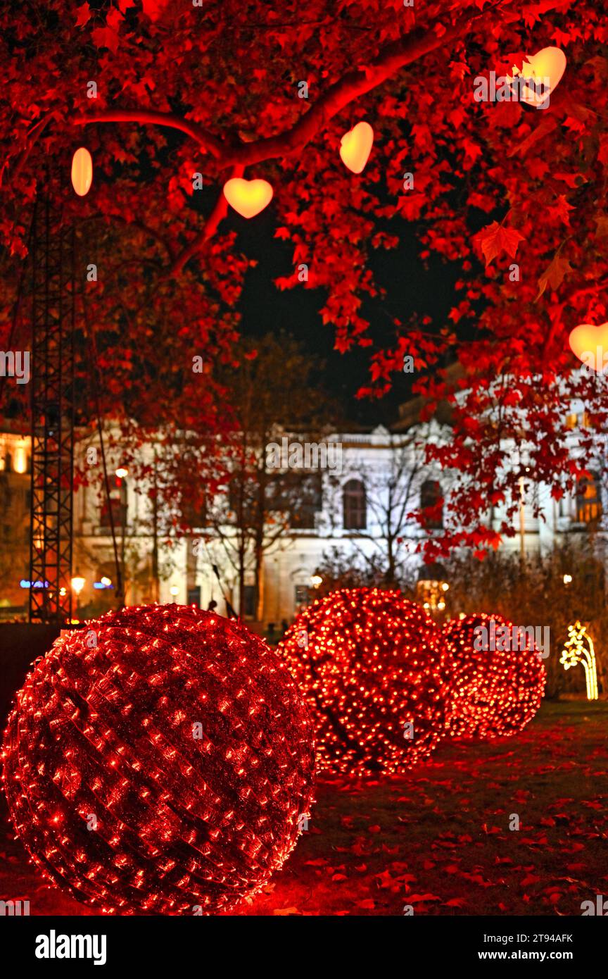 Big red shiny ball Christmas decorations in the park Rathaus at night ...