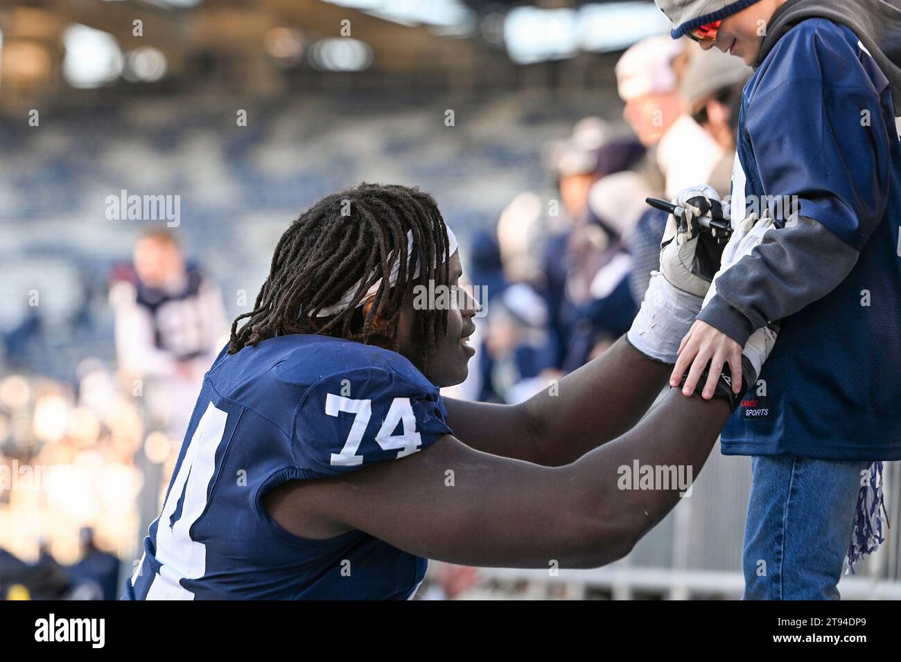 Penn State offensive lineman Olumuyiwa Fashanu (74) signs an autograph ...