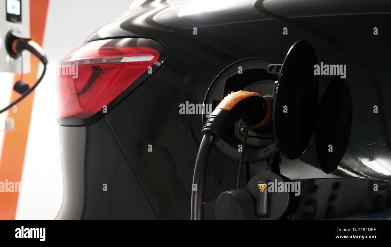 Electric Vehicle car or EV Car parking at charging station and plugged ...