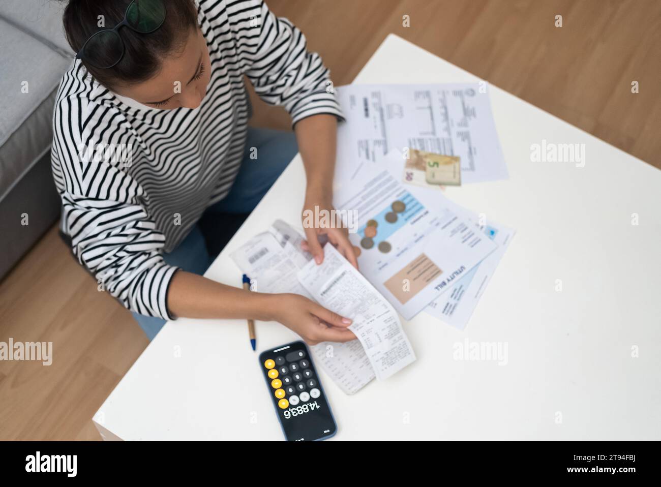 Lady does paperwork calculating regular payment by loan mortgage contract using mobile phone ...