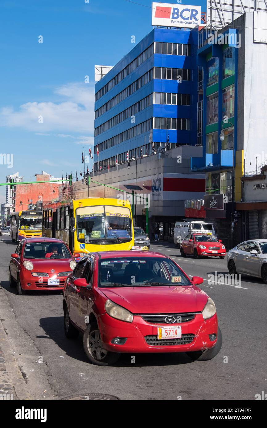 Red taxis and car and bus traffic on Second Avenue, San Jose city ...