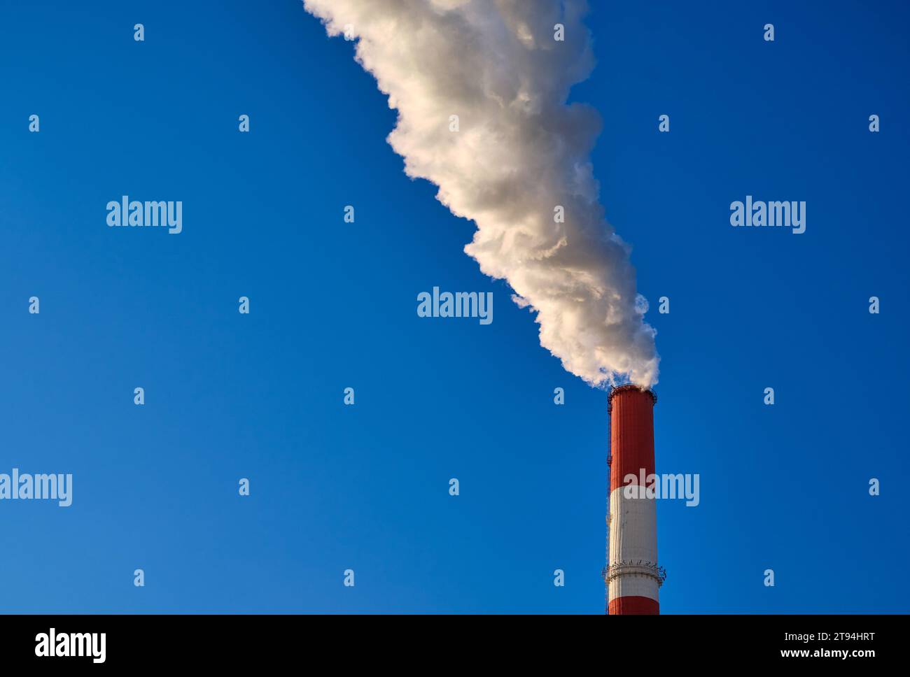 Smoke stack with white steam over blue sky Stock Photo - Alamy