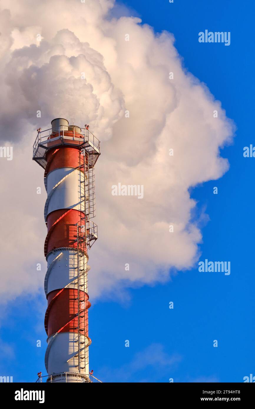 Smoke stack with white steam over blue sky Stock Photo - Alamy