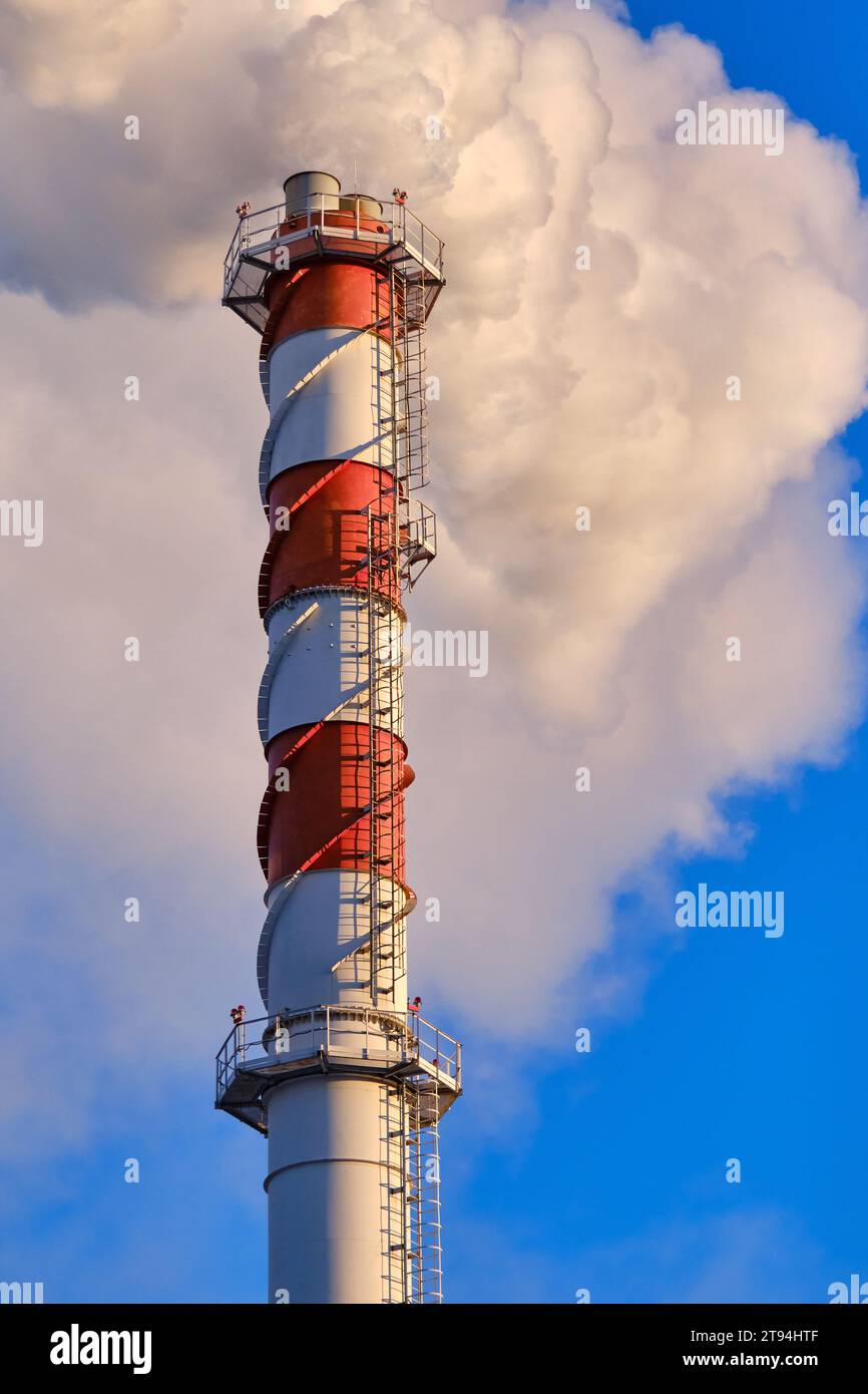 Smoke stack with white steam over blue sky Stock Photo - Alamy
