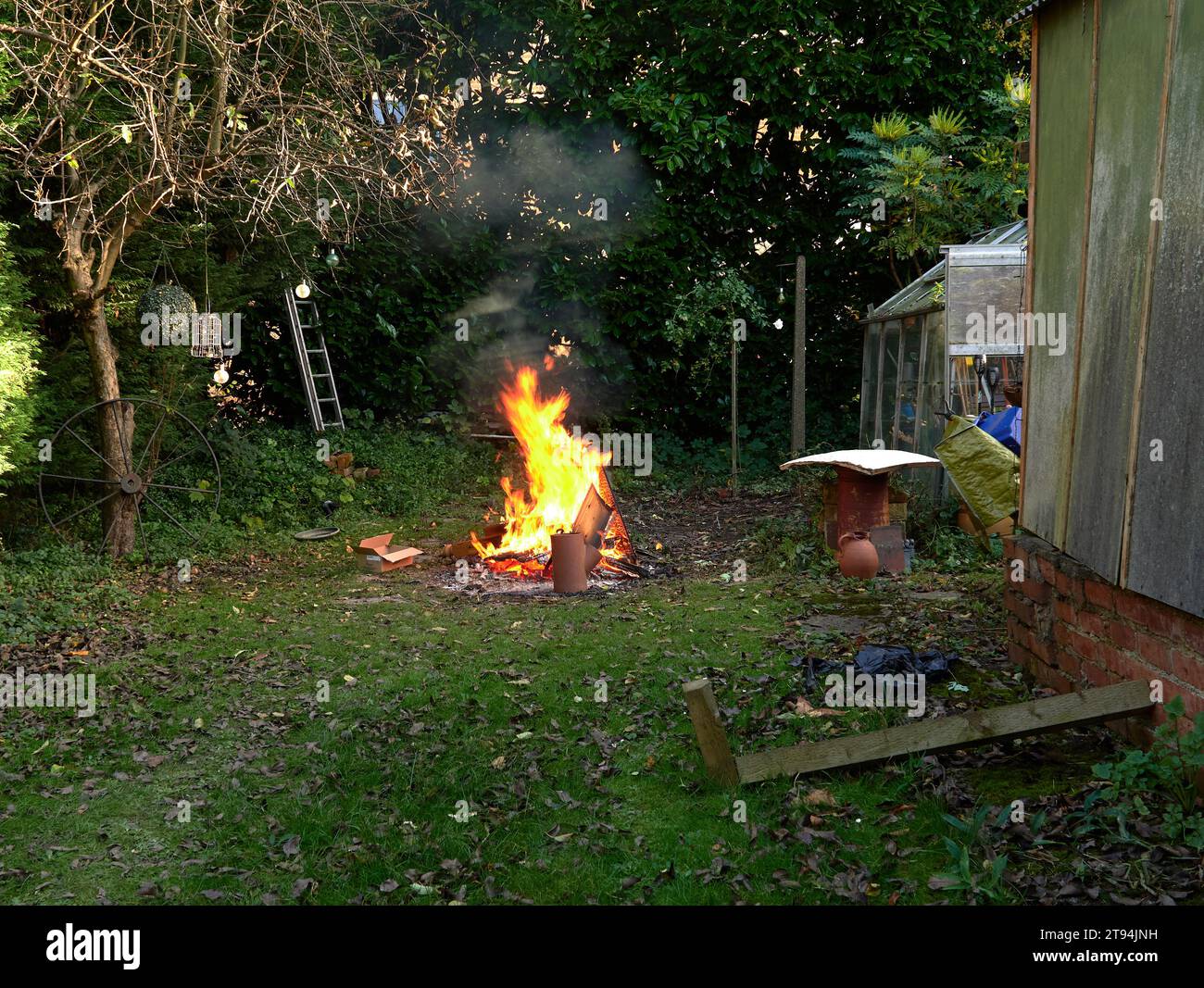 Wood burning on a garden bonfire Stock Photo - Alamy