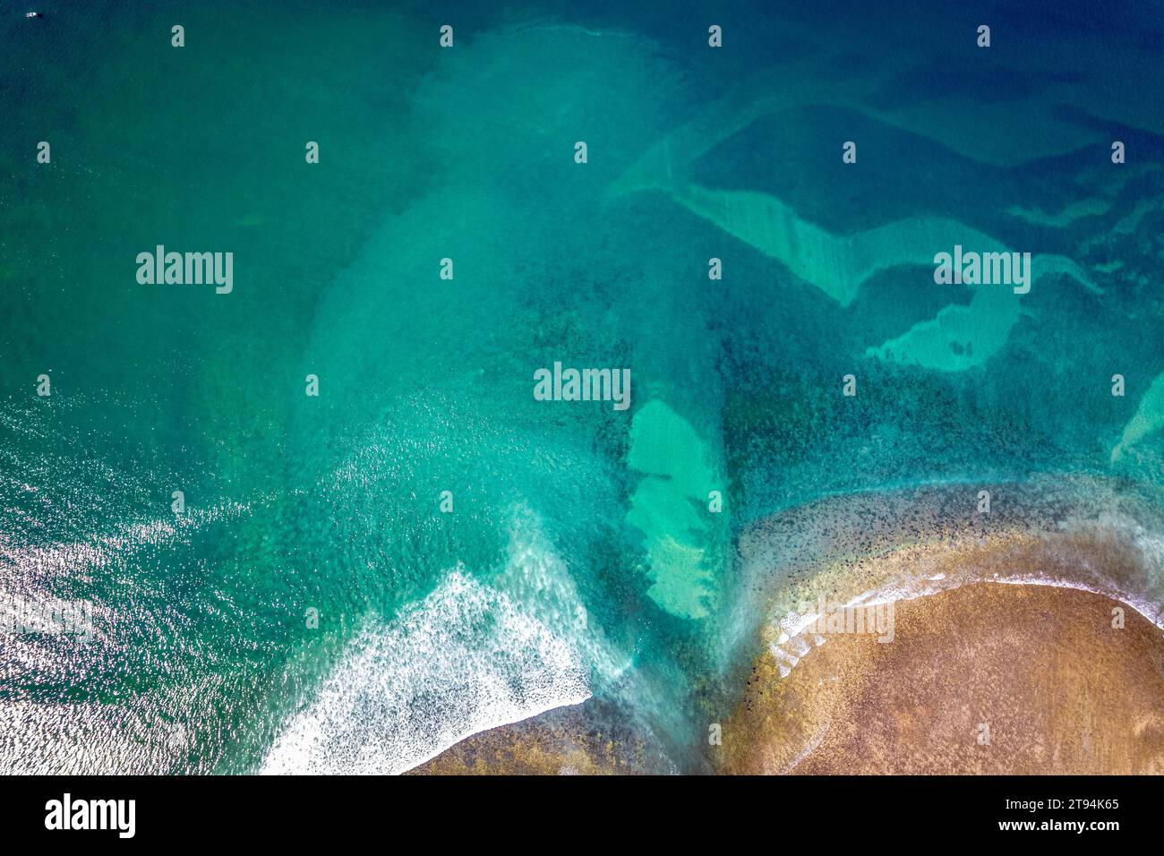 This image captures a picturesque beach scene featuring a tranquil body ...