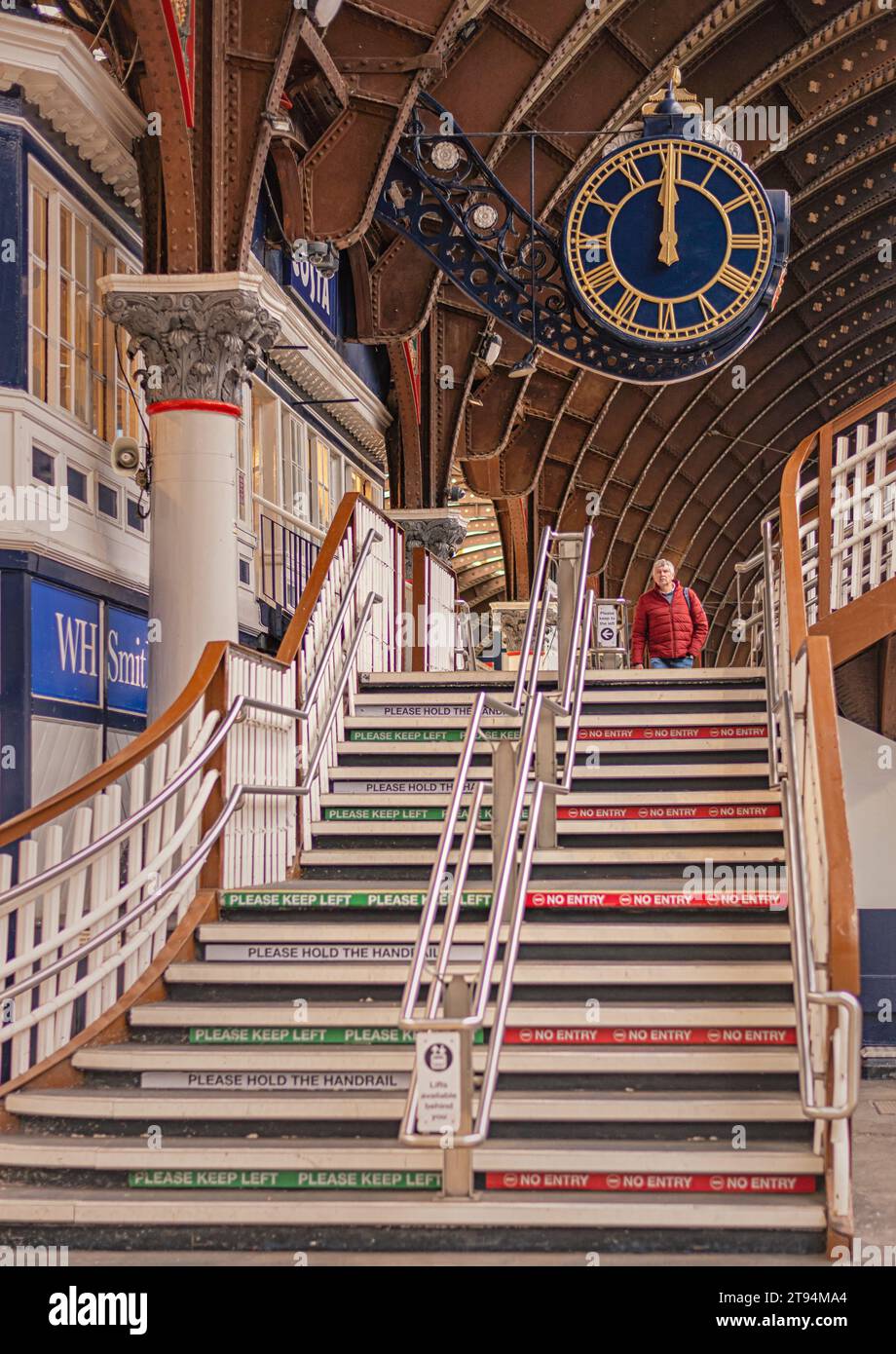 A staircase set on a railway station concourse leads up to a large ...