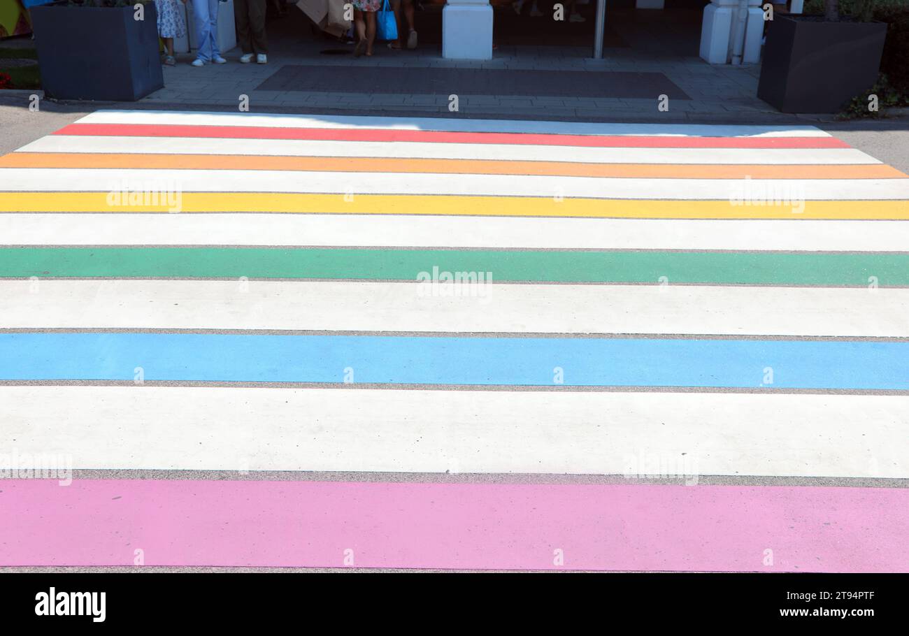 pedestrian crossing with wide colored stripes of rainbow colors in the ...