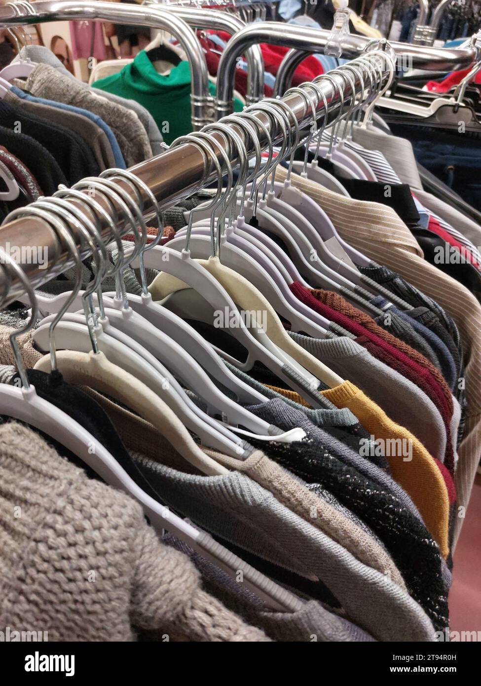 many clothes hanging on hangers in used clothing store Stock Photo - Alamy
