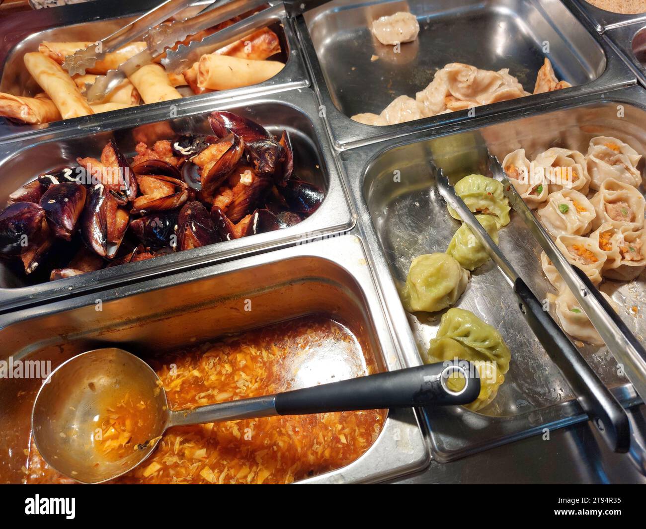 many dishes in a well-stocked Chinese restaurant on stainless steel ...