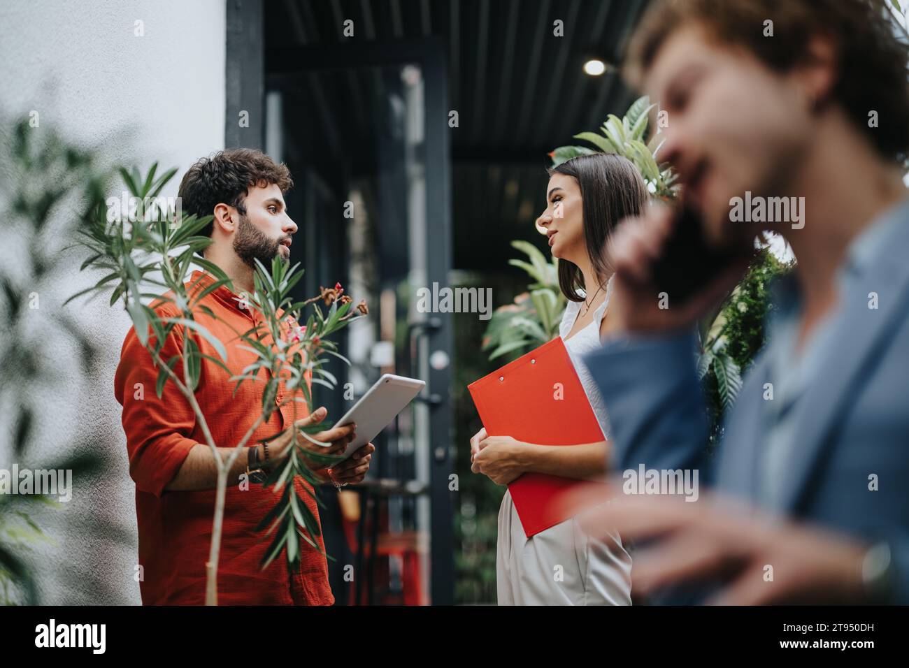 Collaborative Architects Discussing Blueprint at Construction Site ...