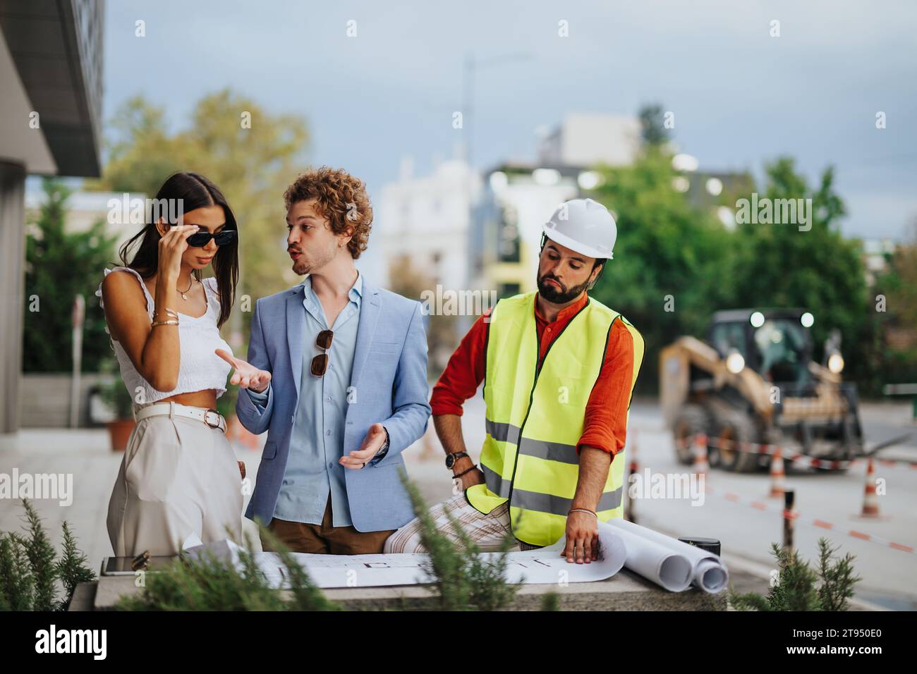 Diverse group of architects and engineers collaborating outdoors ...
