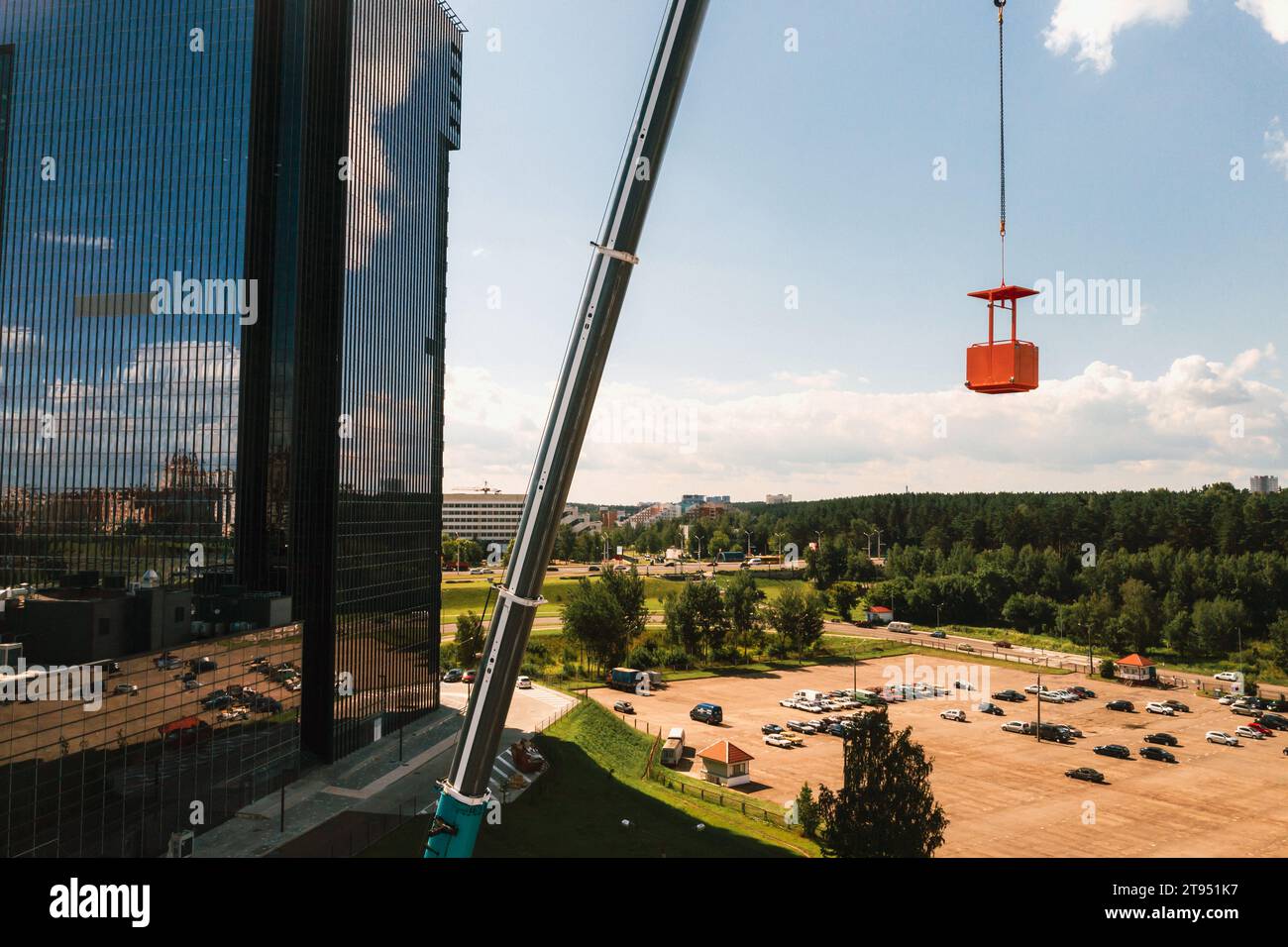 view from the height of the car of a heavy crane with a cradle, which ...