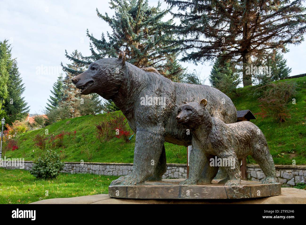 The statue of a mother bear with her cub in the traditional mountainous ...