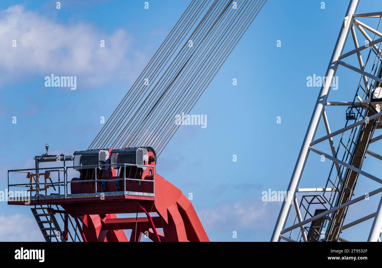 Focus on detail of cables and gears of heavy industrial crane jib used ...