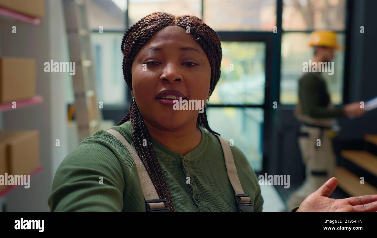 African american warehouse manager using selfie smartphone camera ...