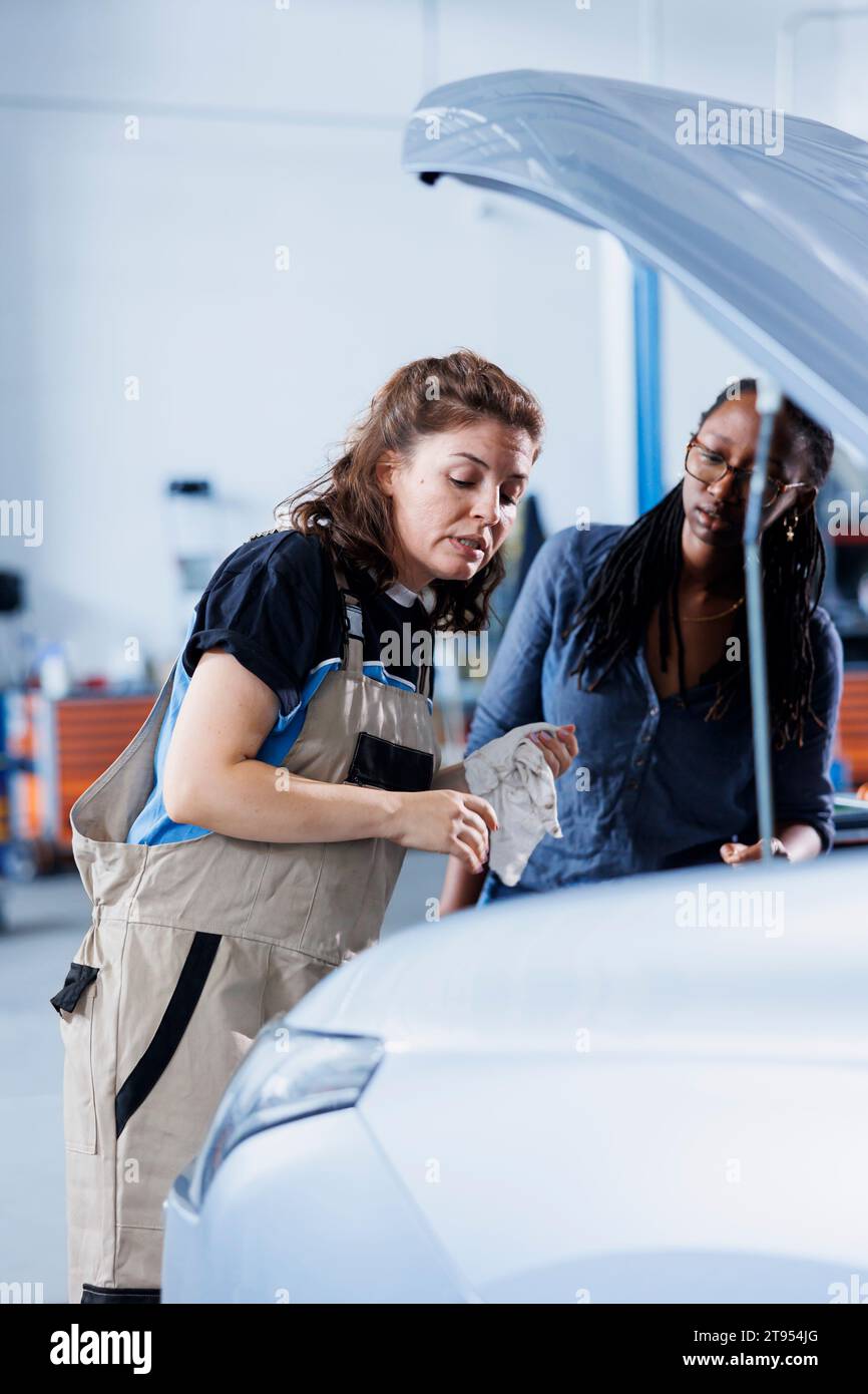 Woman underneath car hi-res stock photography and images - Alamy