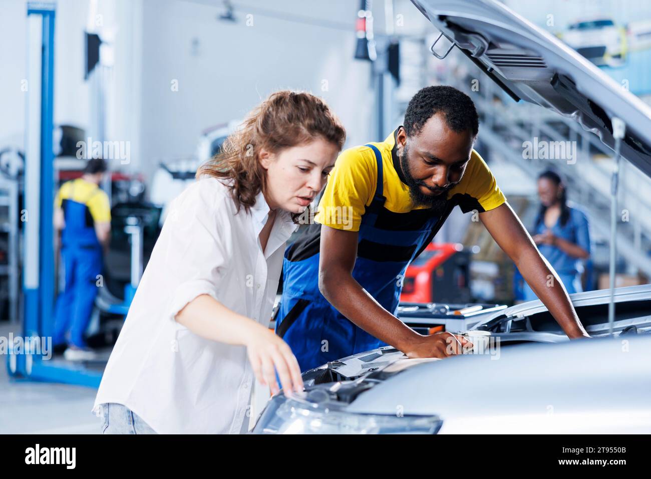 Mechanic at auto repair shop conducts annual vehicle checkup, informing ...