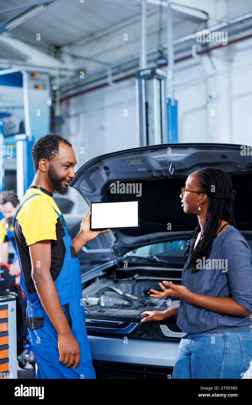 Licensed mechanic in car service uses mockup tablet to order new ...
