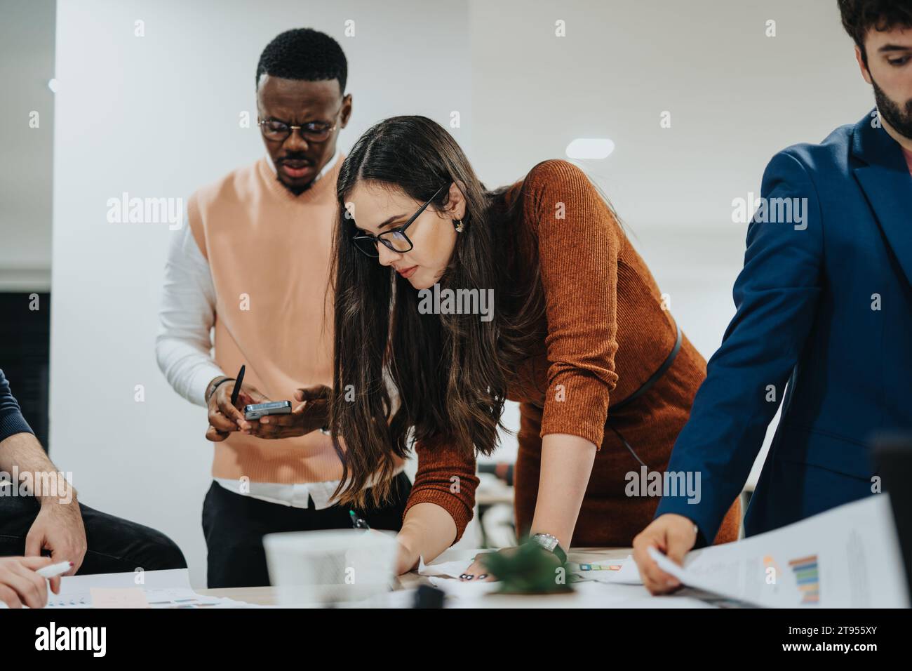 Multiracial corporate team working late into the night, brainstorming ...