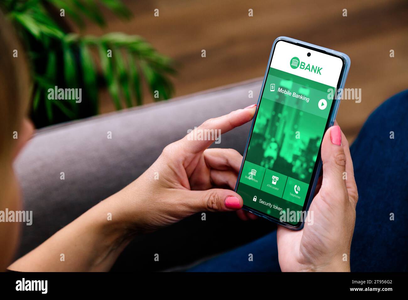 Mobile banking application on phone screen. Woman holding smartphone ...