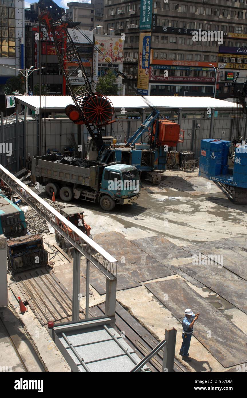 Digger working in a building site during construction of a new office ...