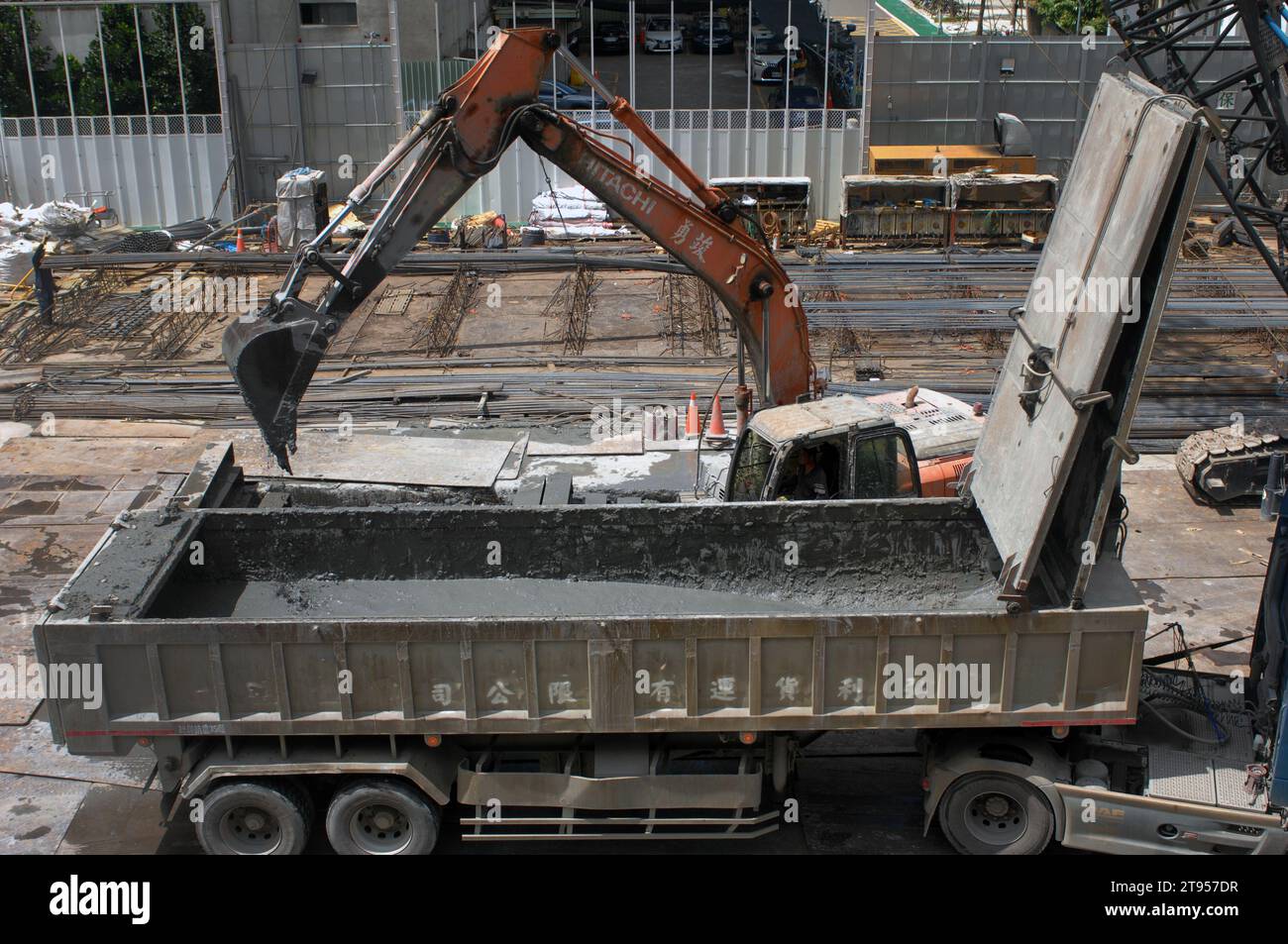 Digger working in a building site during construction of a new office ...