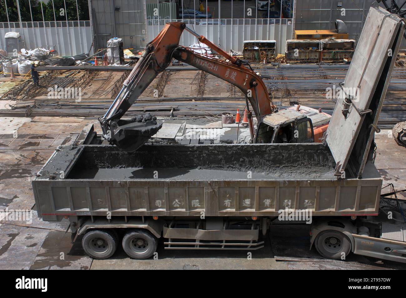Digger working in a building site during construction of a new office ...