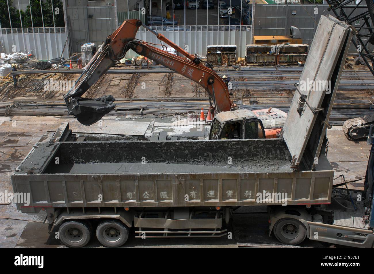 Digger working in a building site during construction of a new office ...