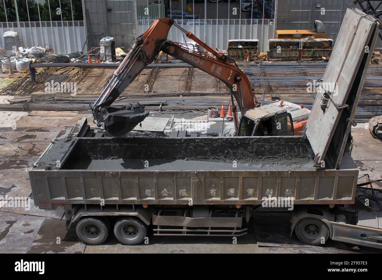 Digger working in a building site during construction of a new office ...