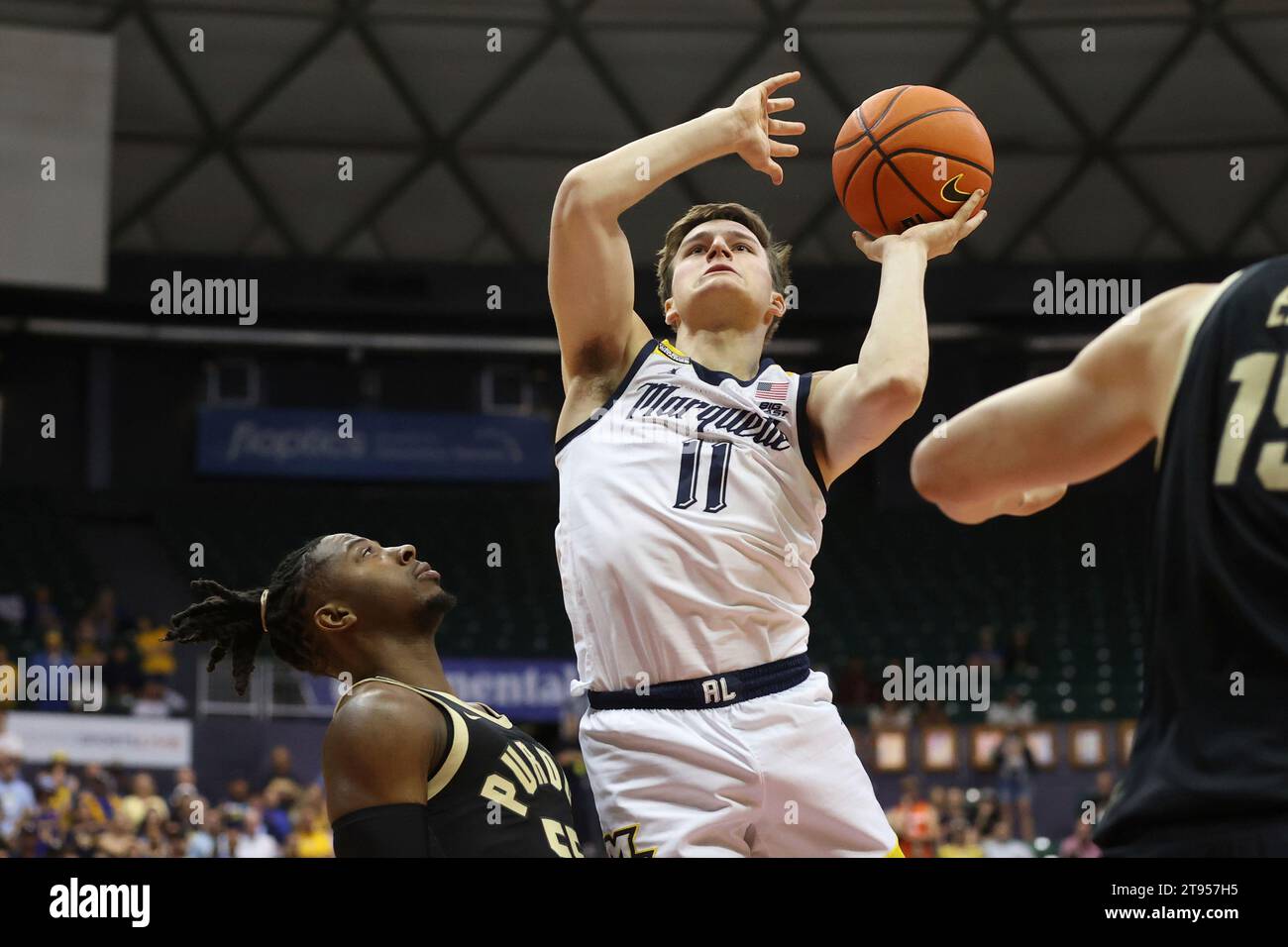Marquette guard Tyler Kolek (11) shoots over Purdue guard Lance Jones ...