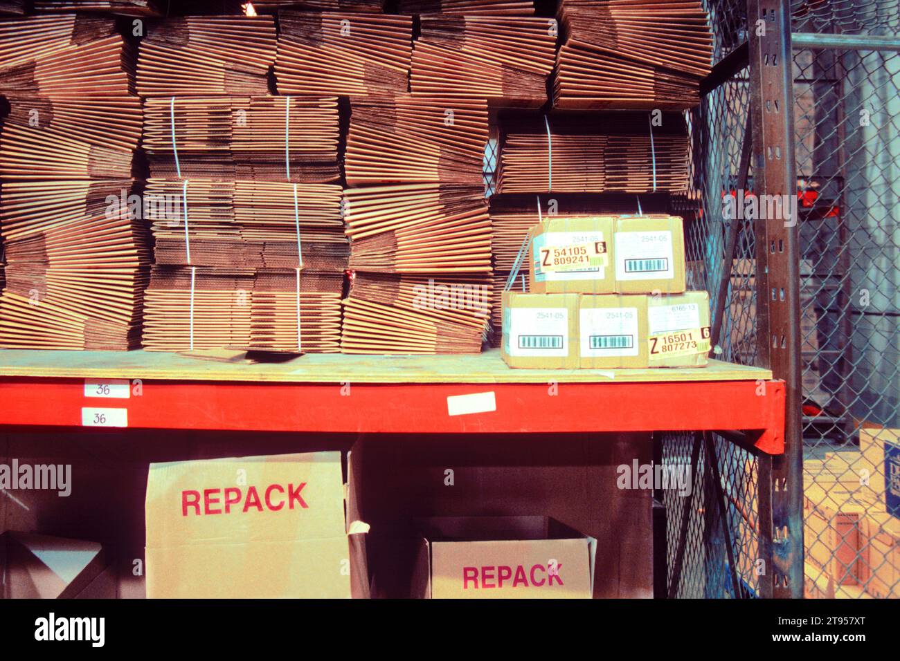 Unloading cardboard shipping boxes unassembled, flat packed, inside a ...