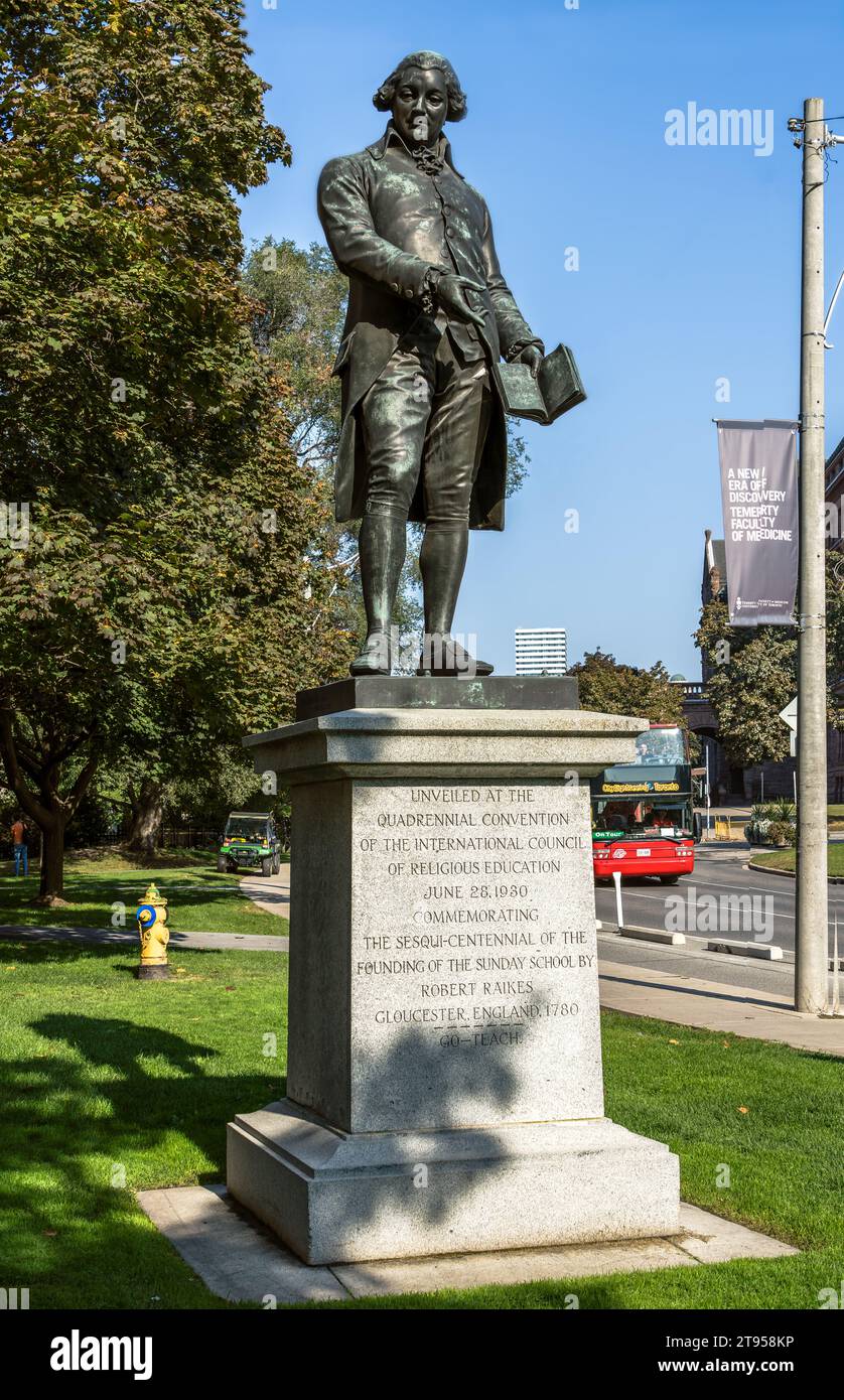 Toronto, Canada, October 2, 2023:Robert Raikes Statue with blue sky ...
