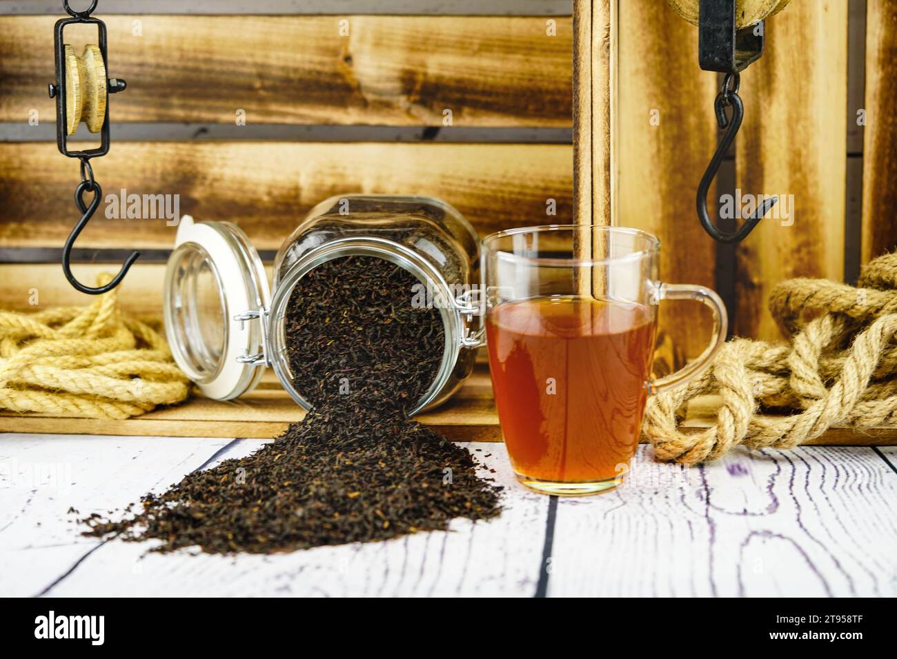 dry tea leaves in glass jar, glass of tea and rope Stock Photo - Alamy