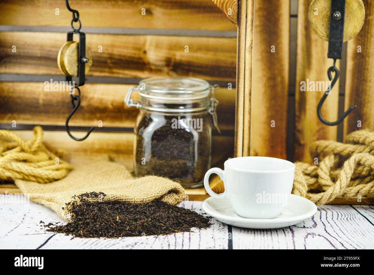 dry tea leaves, cup of glass, glass jar, sack and rope Stock Photo - Alamy
