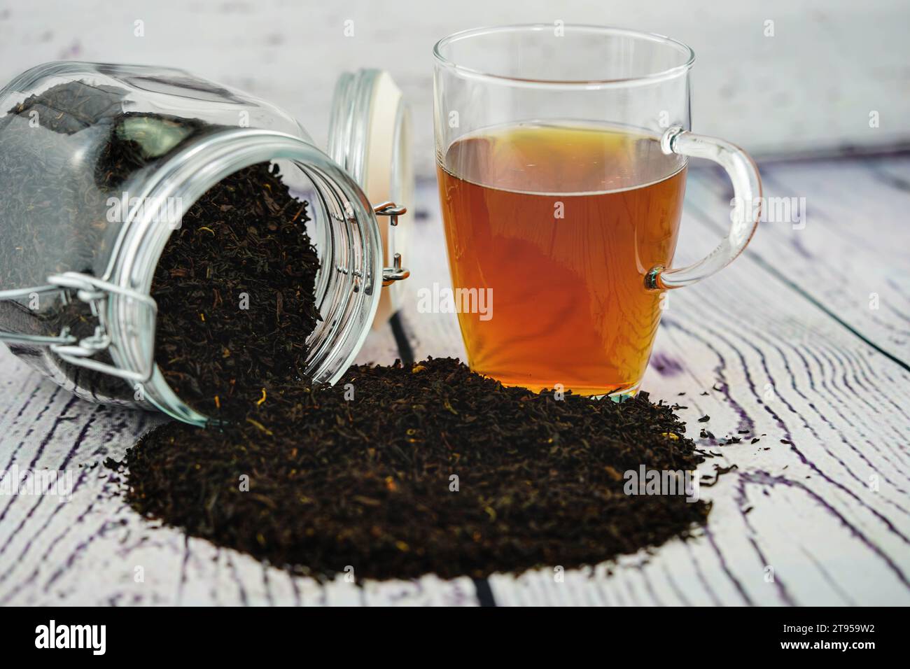 dry tea leaves with glass jar and glass of tea Stock Photo - Alamy