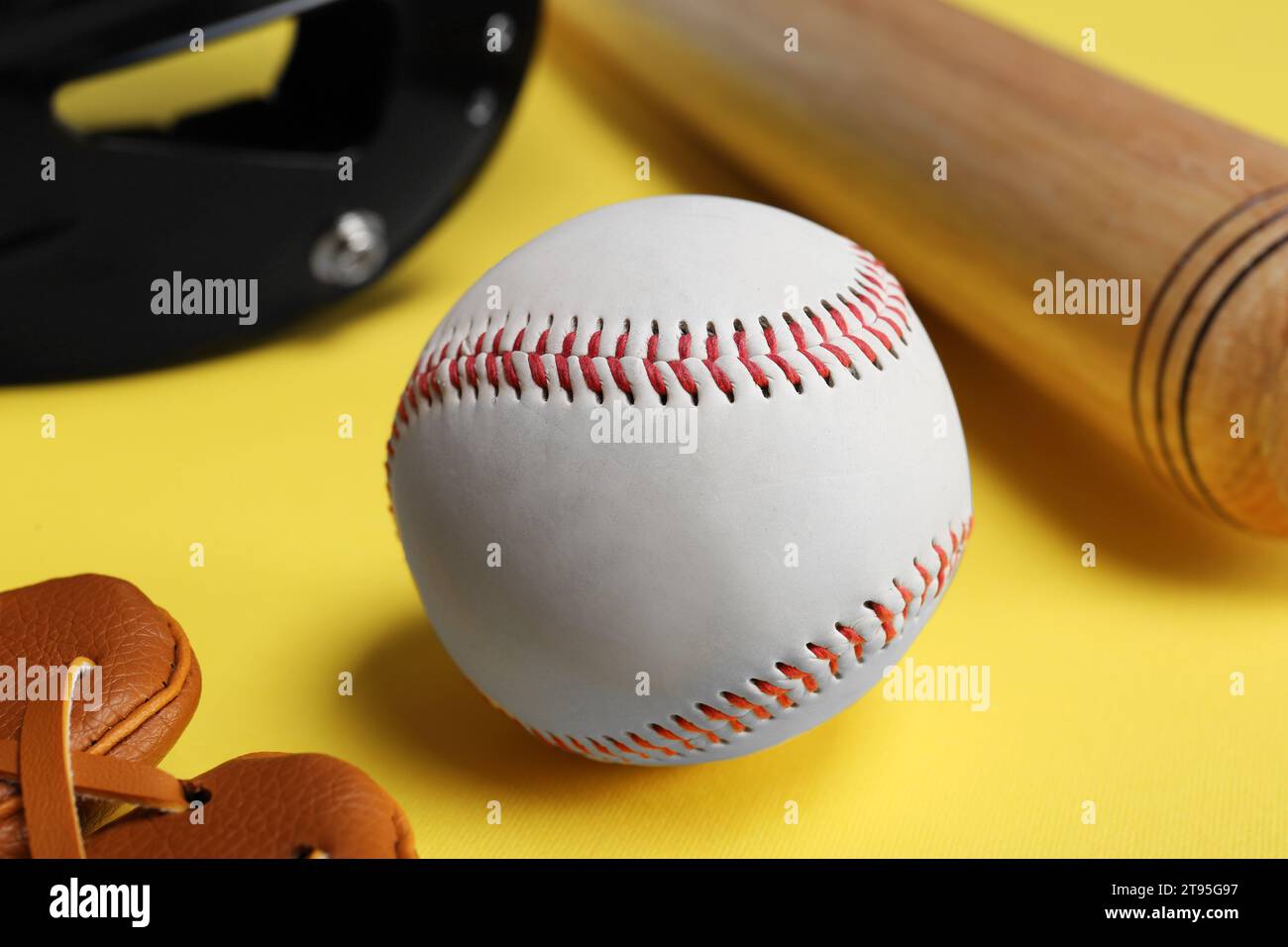 Baseball ball and bat on yellow background, closeup Stock Photo - Alamy