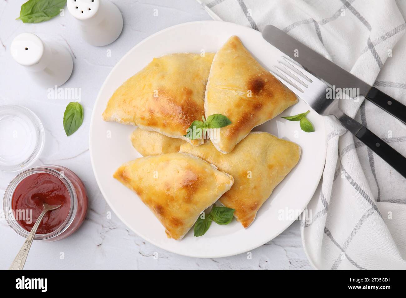 Delicious samosas served on white textured table, flat lay Stock Photo ...