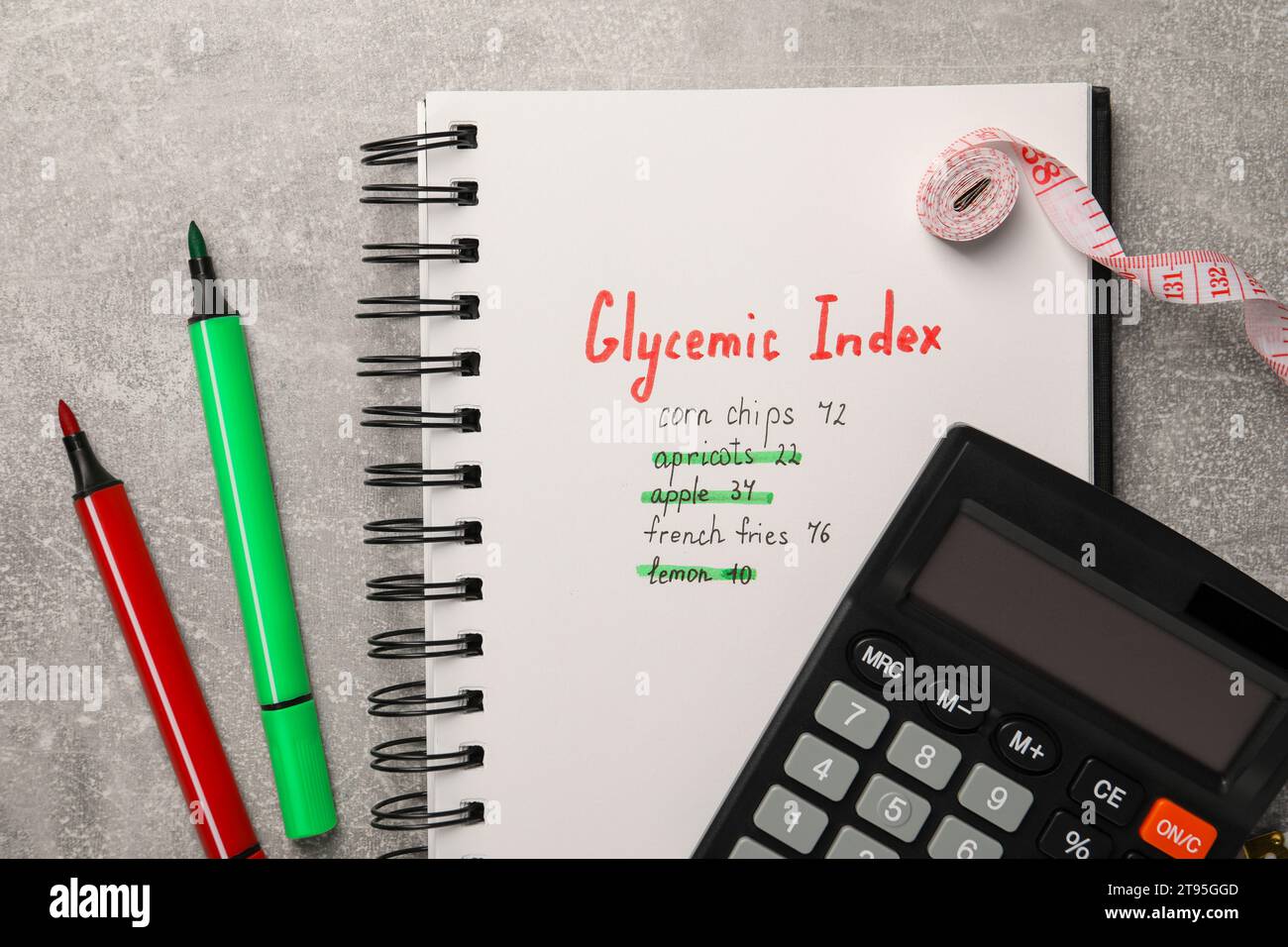 Glycemic Index. Notebook with information, markers, calculator and ...