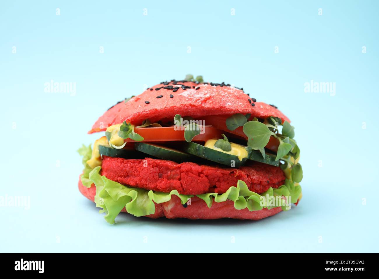 Tasty pink vegan burger with vegetables, patty and microgreens on light ...