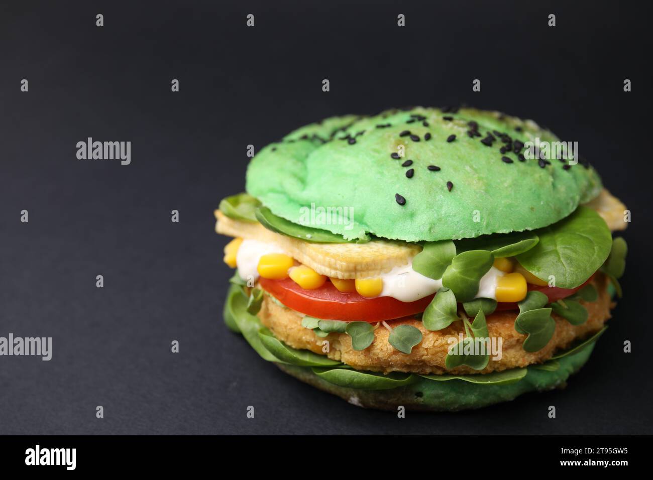 Tasty green vegan burger with vegetables, patty and microgreens on ...