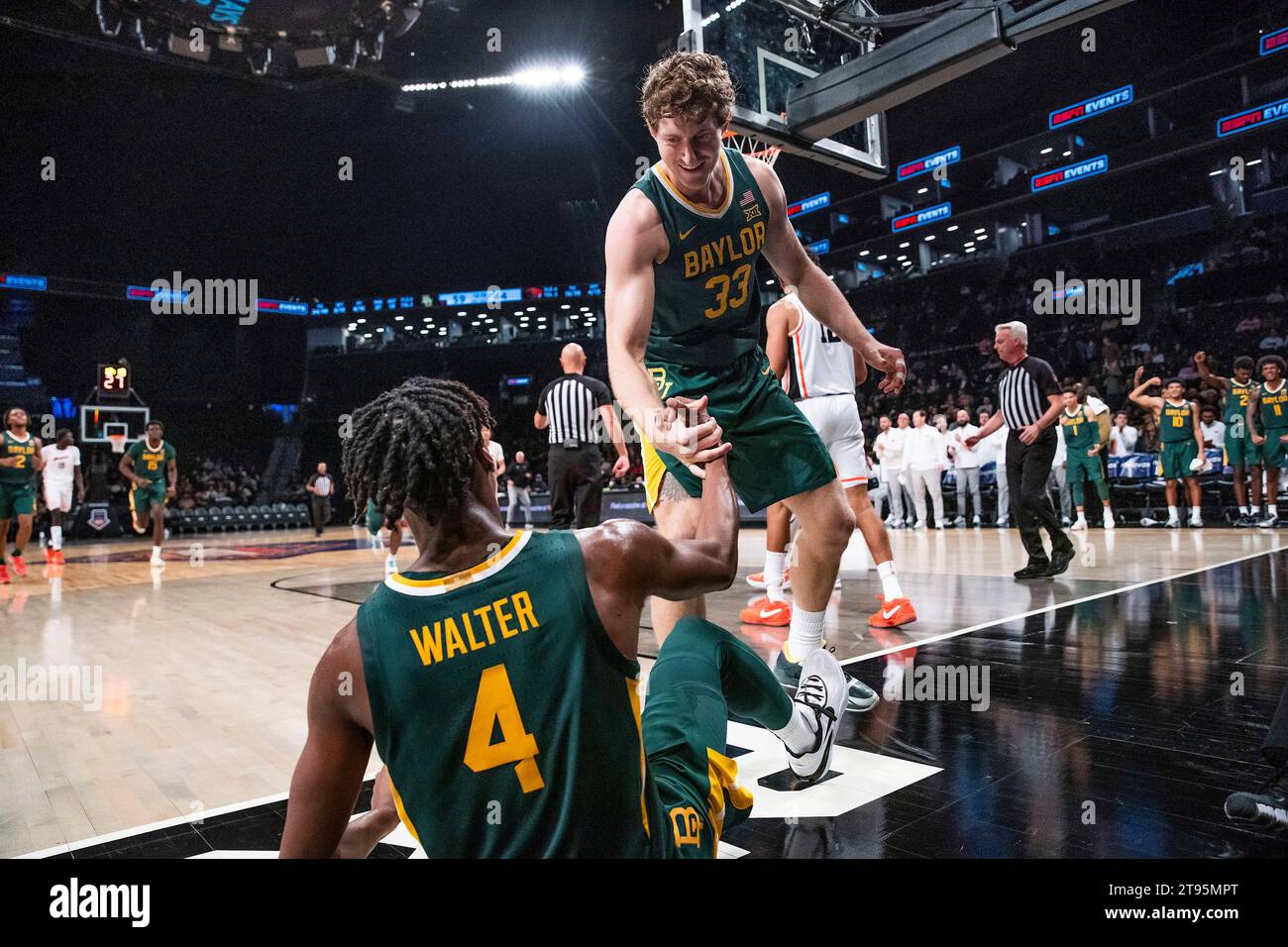 Baylor forward Caleb Lohner (33) helps Ja'Kobe Walter (4) up after a ...