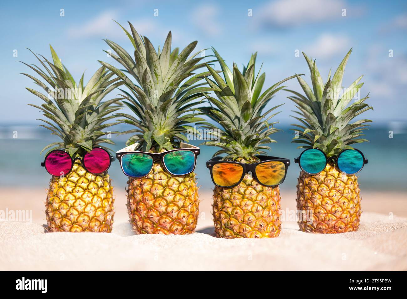 Two pineapples with trendy sunglasses on the beach Stock Photo - Alamy