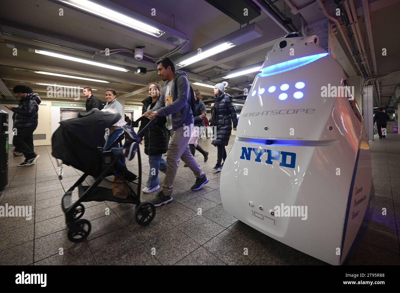 New York, USA. 22nd Nov, 2023. Commuters walk past the NYPD's Knightscope K5 Autonomous Security ...