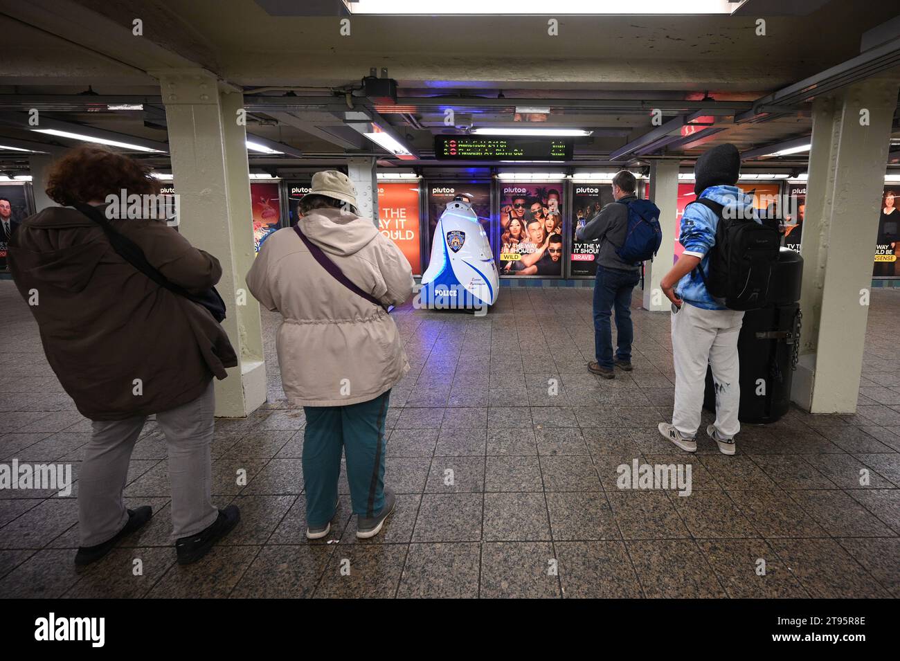 New York, USA. 22nd Nov, 2023. Commuters pause to look at the NYPD's ...