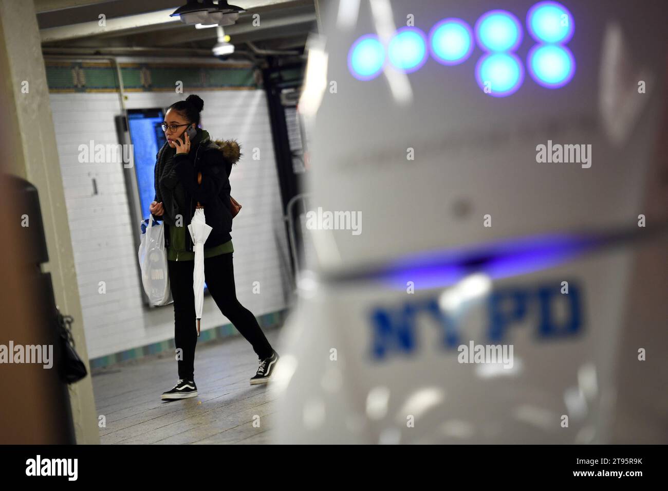 New York, USA. 22nd Nov, 2023. A commuter walks past the NYPD's Knightscope K5 Autonomous ...